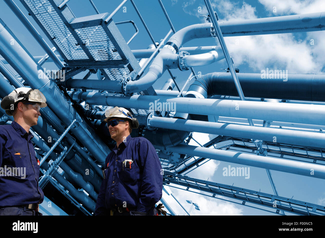 oil and gas workers with pipelines construction Stock Photo - Alamy