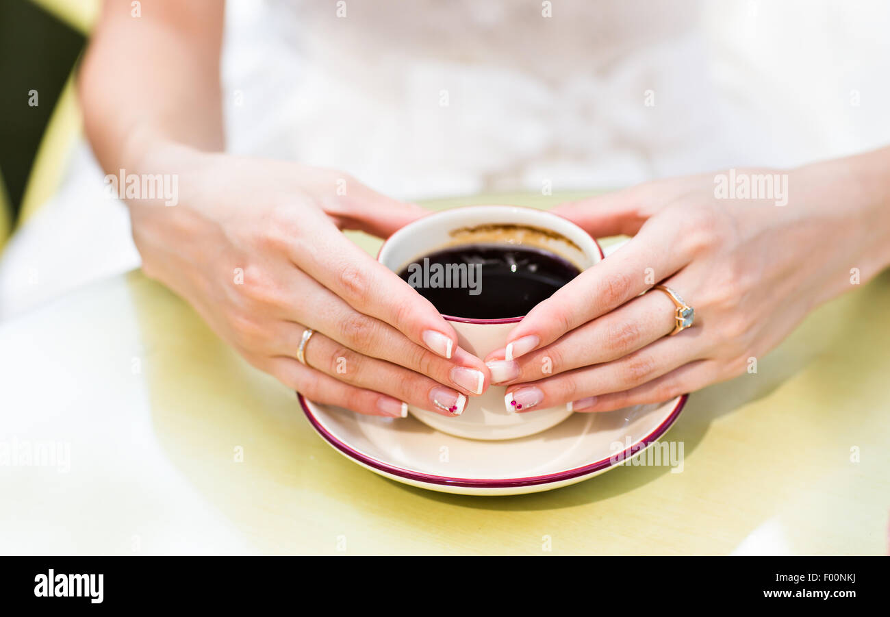 female hands hold a cup of coffee Stock Photo - Alamy