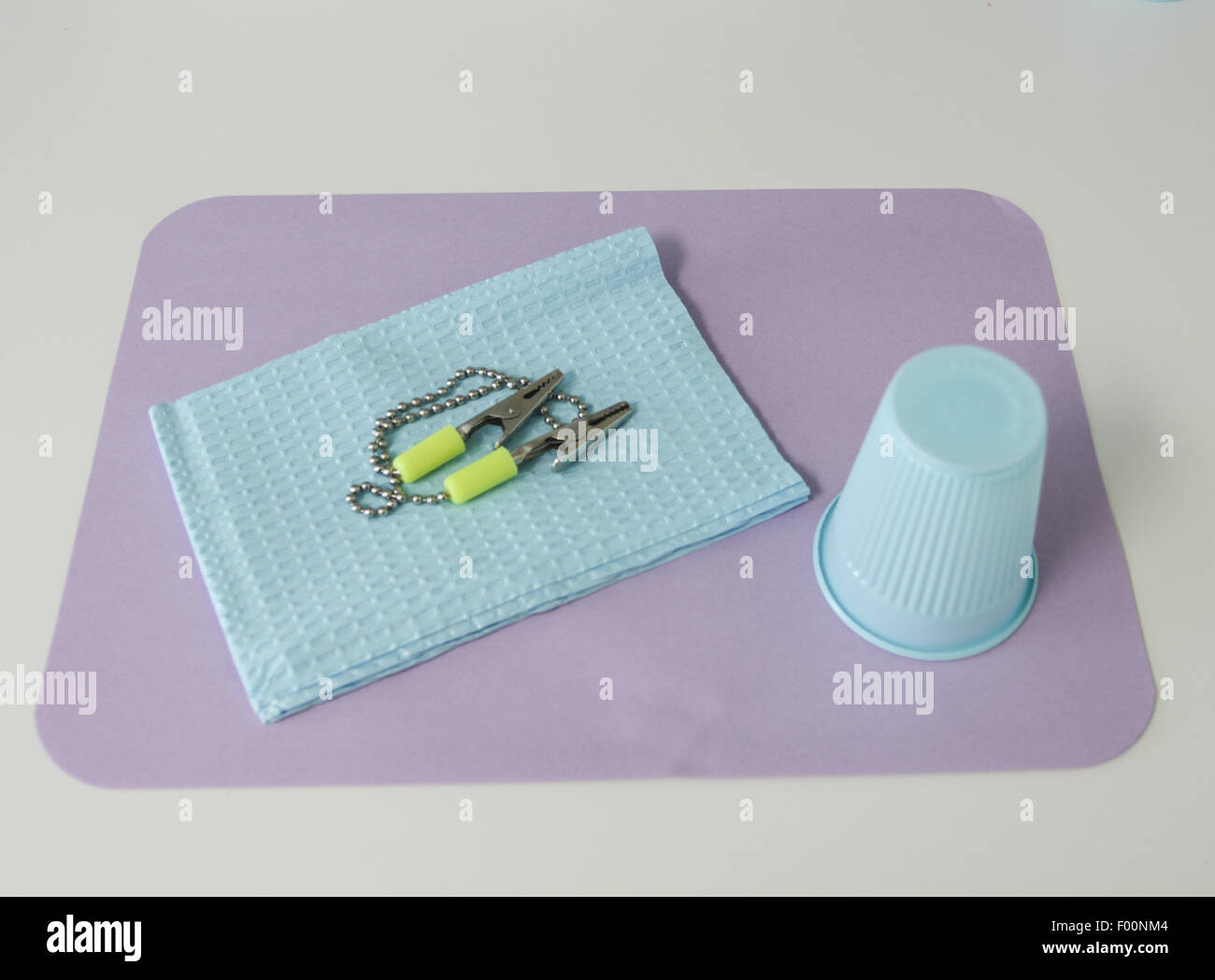 Dental cup, bib, chain and tray liner prepared for dental patients in ...