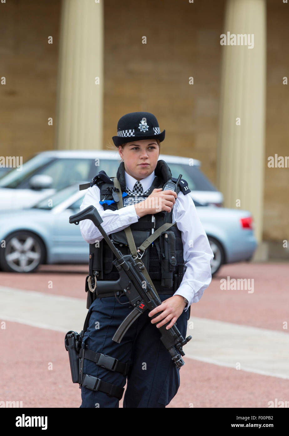 Armed police officers guarding a gateway at Buckingham Palace, London ...
