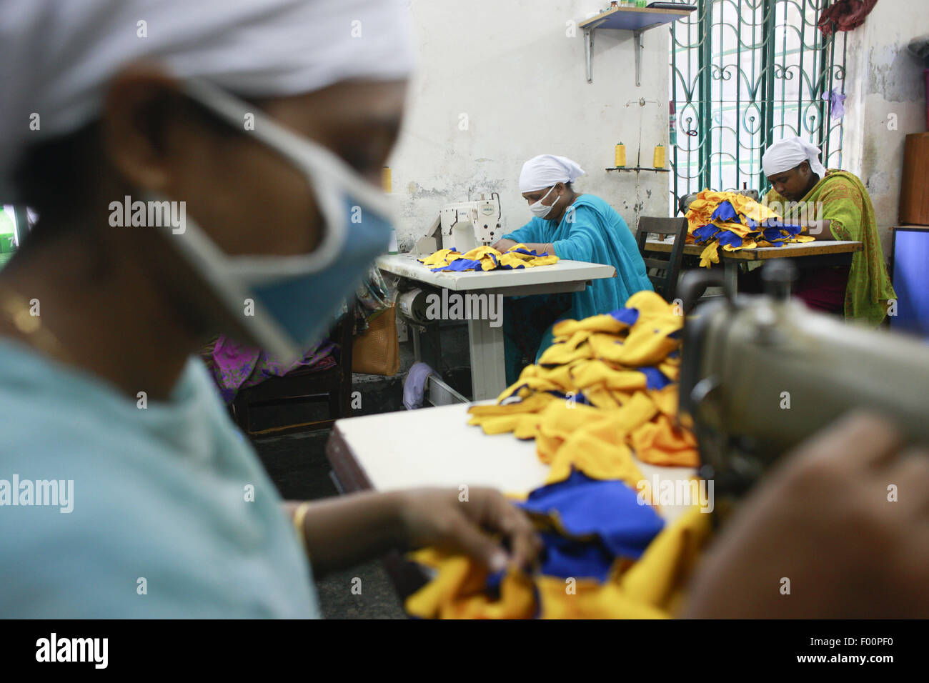 Dhaka, Bangladesh. 5th Aug, 2015. Bangladeshi workers swing fabrics for ...