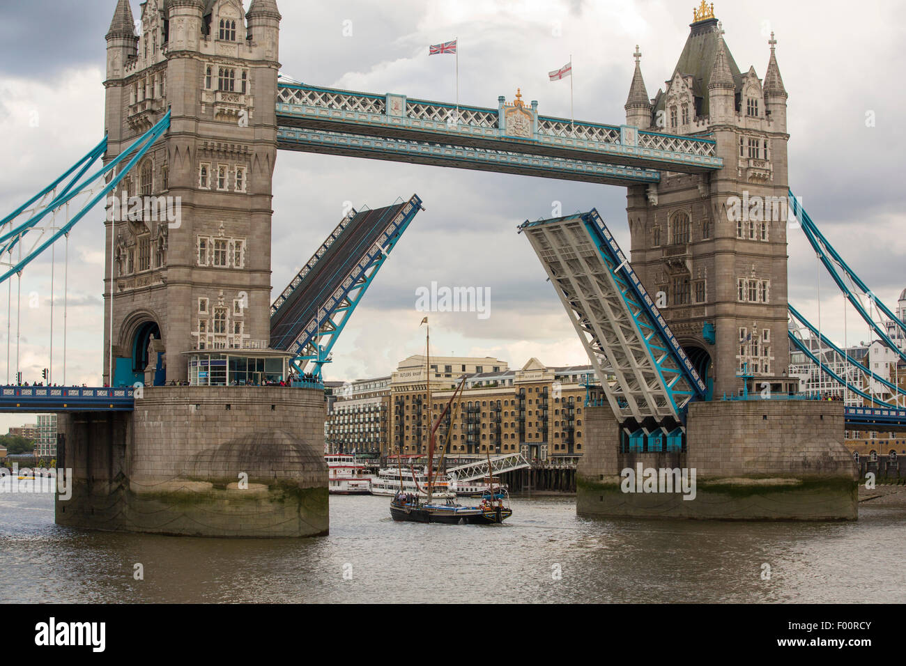 The Iconic Tower Bridge spanning the river Thames, opening to let a ...