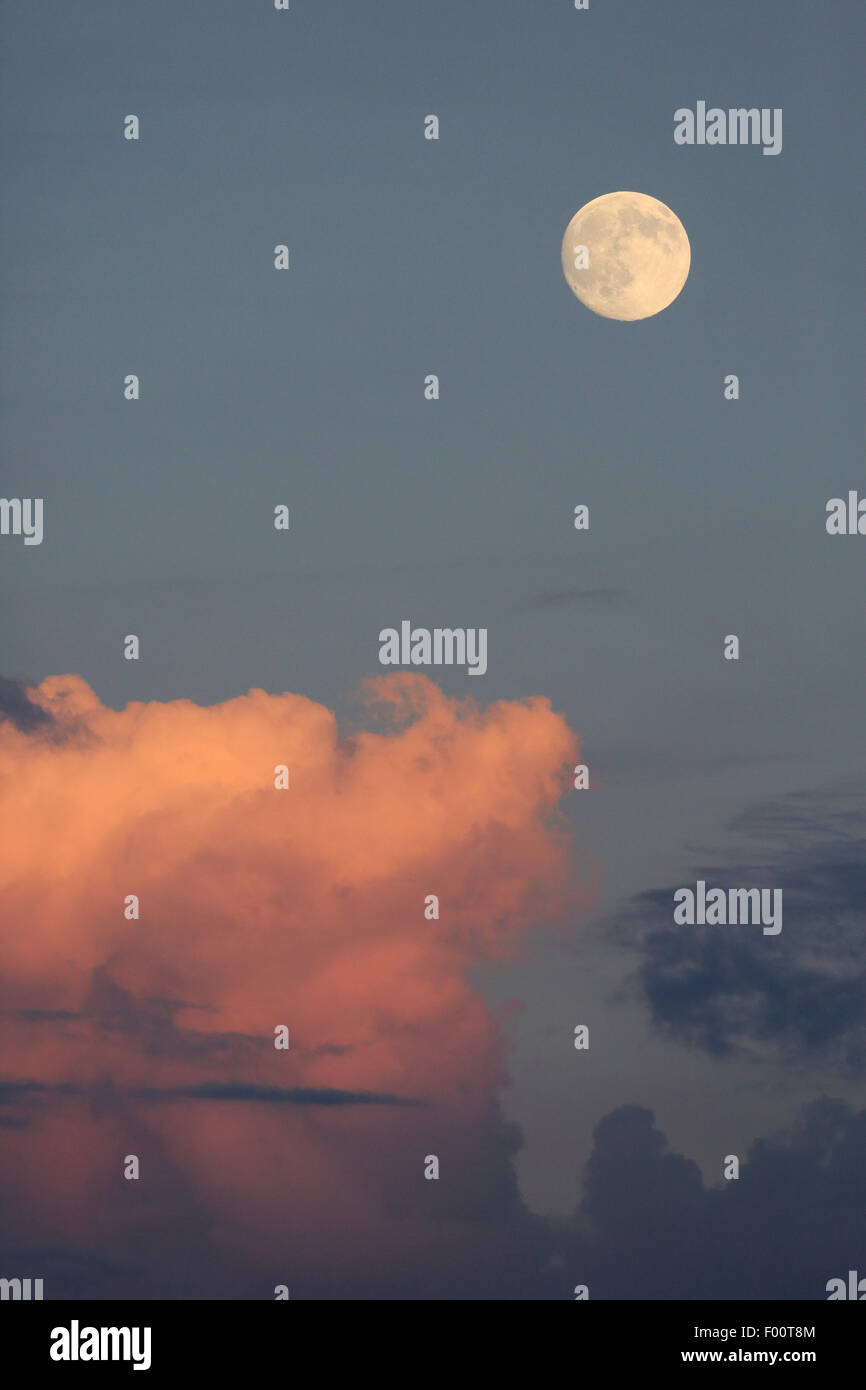 Full Moon at sunset with illuminated clouds Stock Photo - Alamy