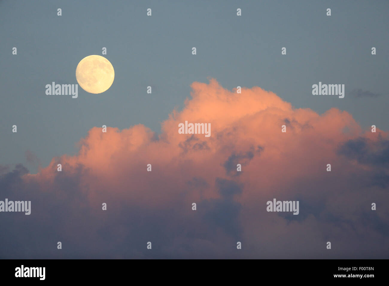Full Moon at sunset with illuminated clouds Stock Photo - Alamy