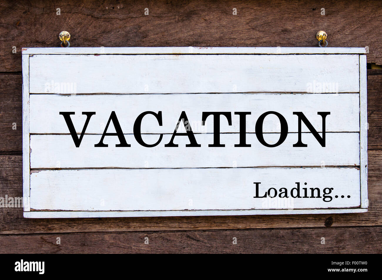 Vacation loading Inspirational message written on vintage wooden board ...