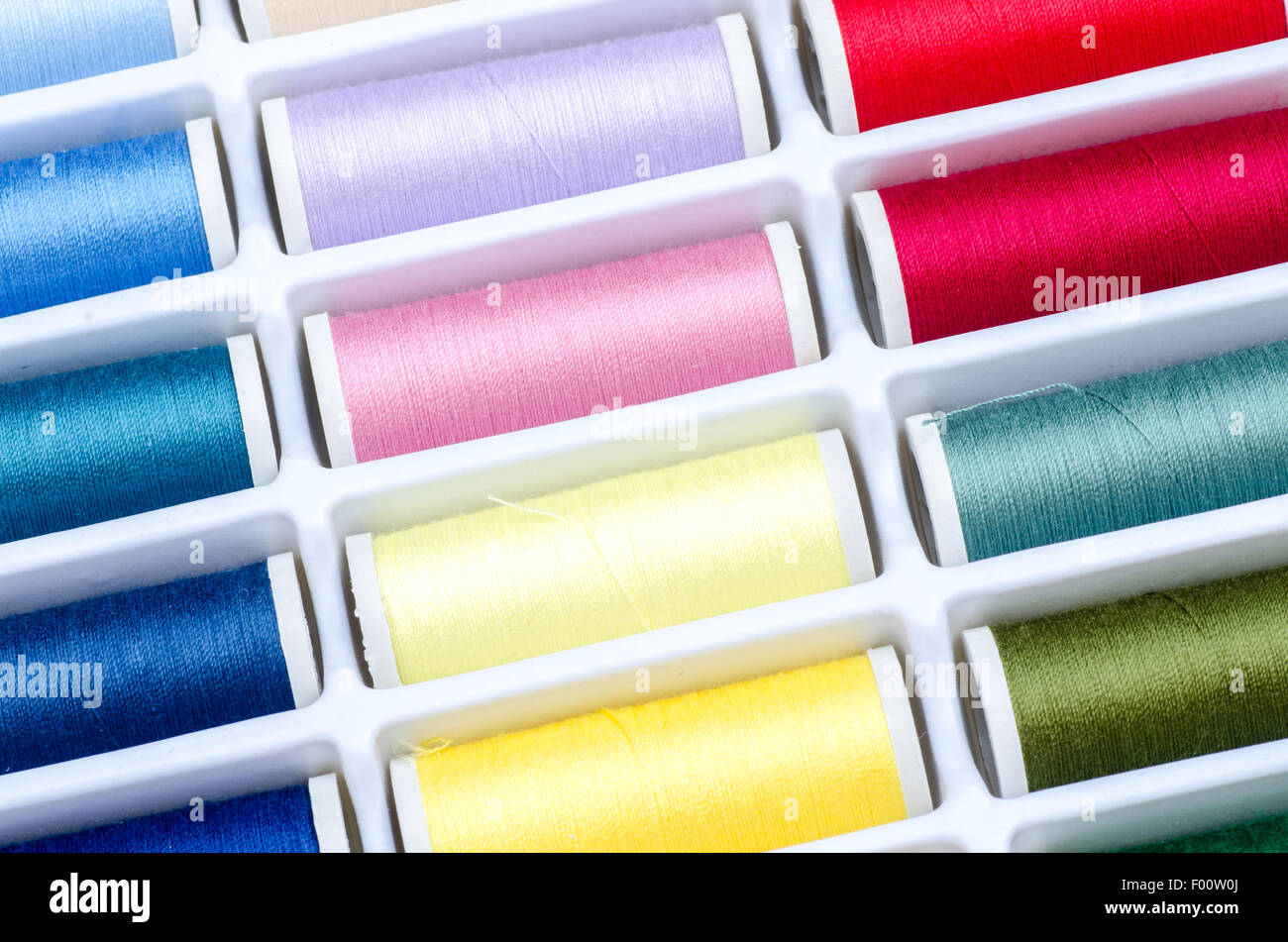 closeup multicolored sewing threads set Stock Photo - Alamy