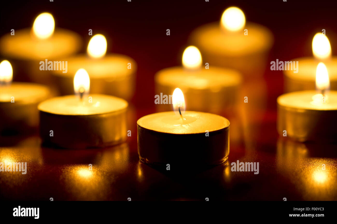 Many lighting candles in hi-res stock photography and images - Alamy