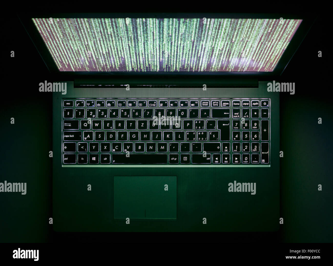 A laptop computer in the dark with illuminated keyboard and mystic ...