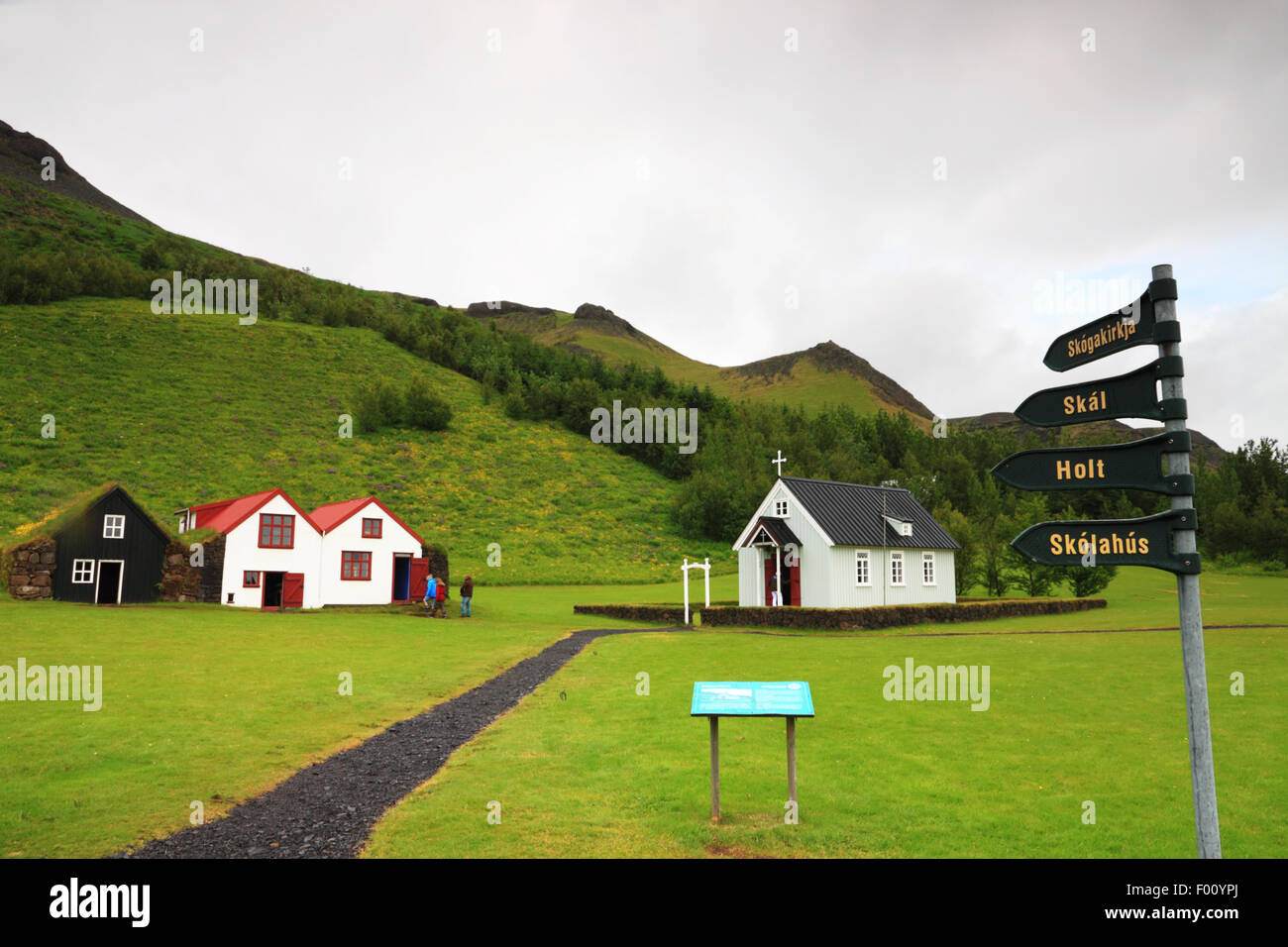 Various traditional Icelandic buildings in a museum setting beside a ...