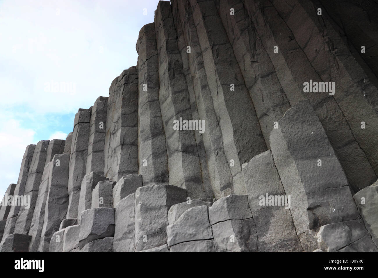Looking up at a cliff face of vertical hexagonal basalt columns Stock ...