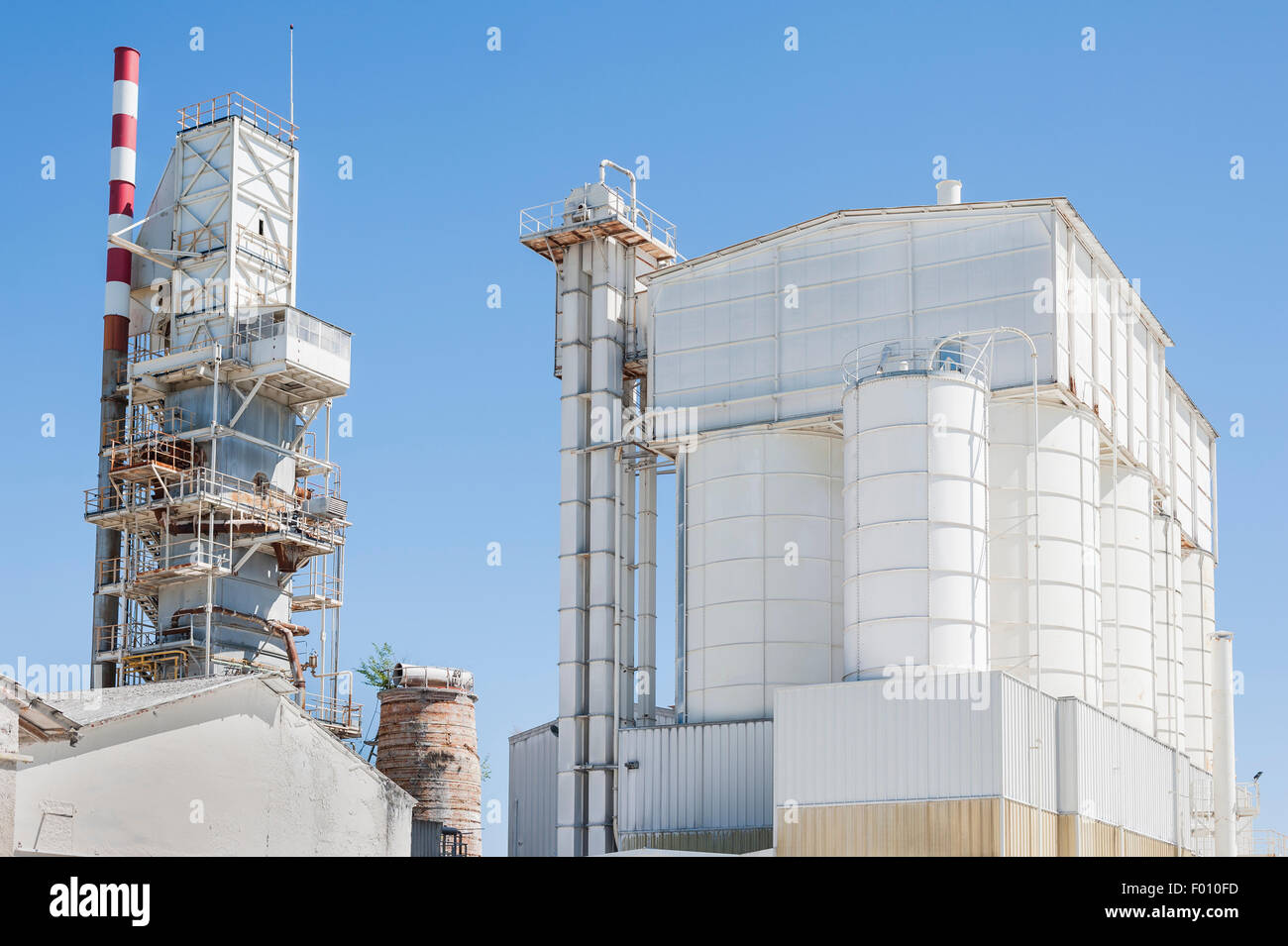 Old cement plant. Preheating tower and storage silos Stock Photo - Alamy