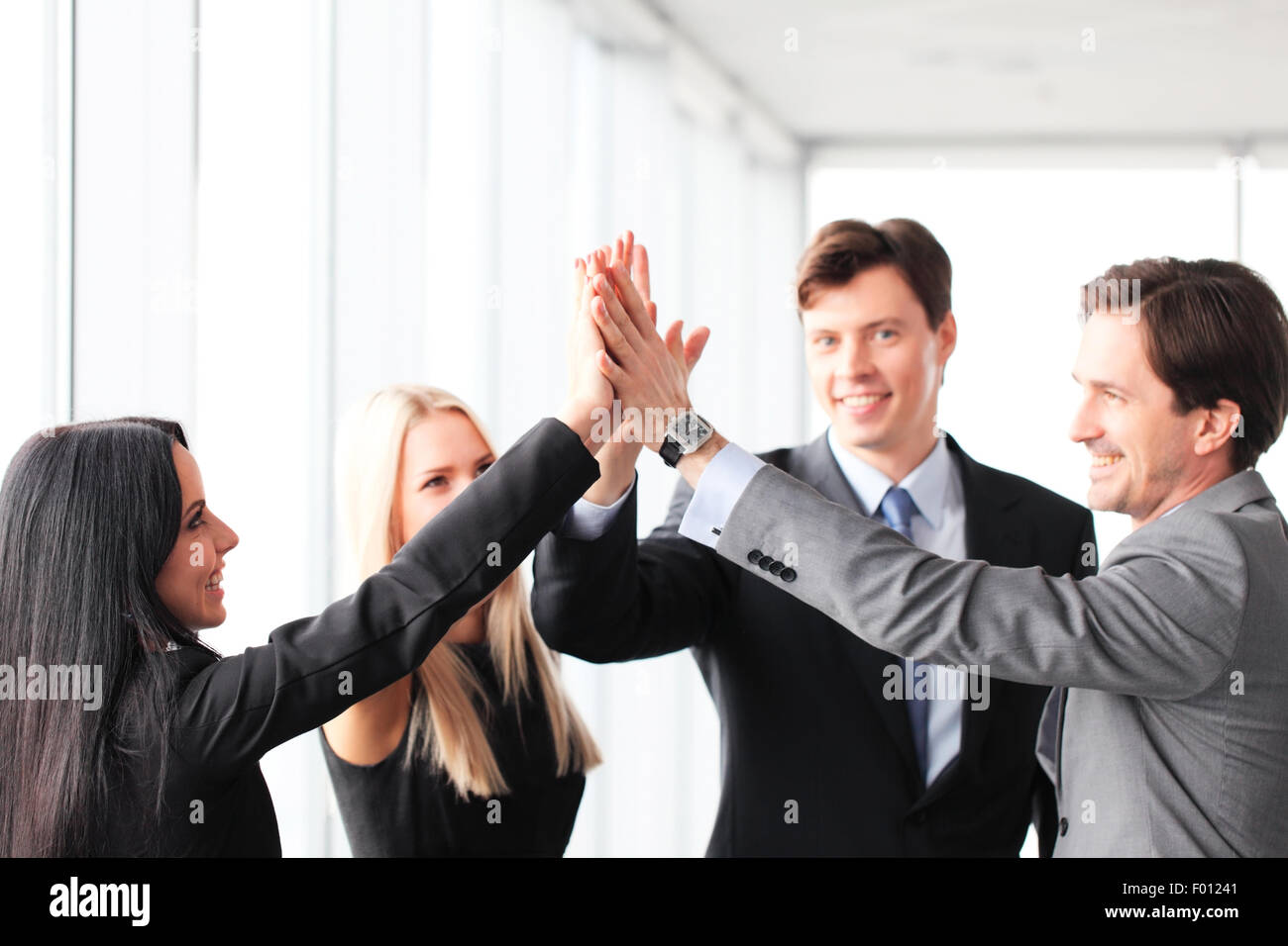 Business people giving high five Stock Photo - Alamy