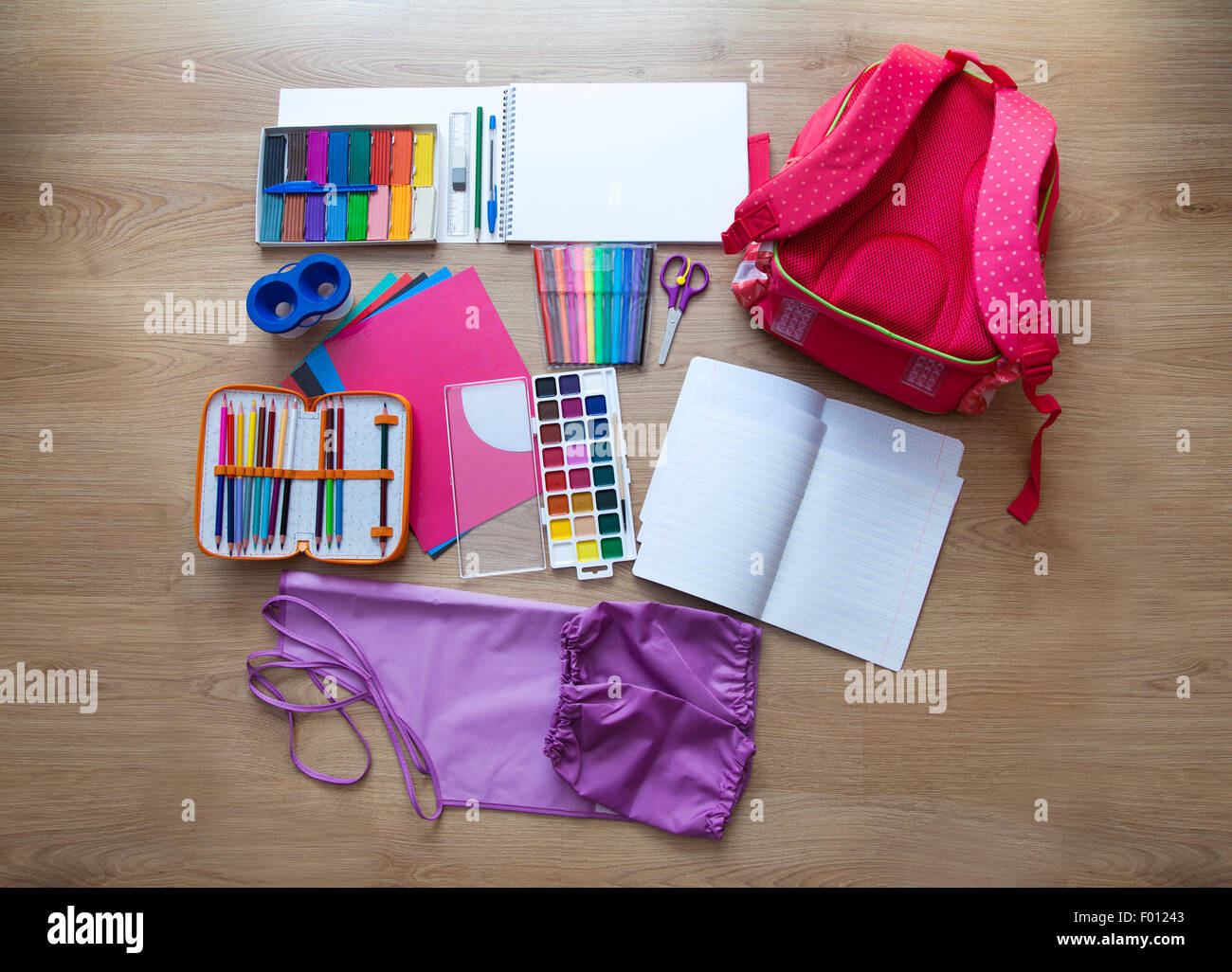 set of school supplies. red backpack, pen, pencil, clored paper ...