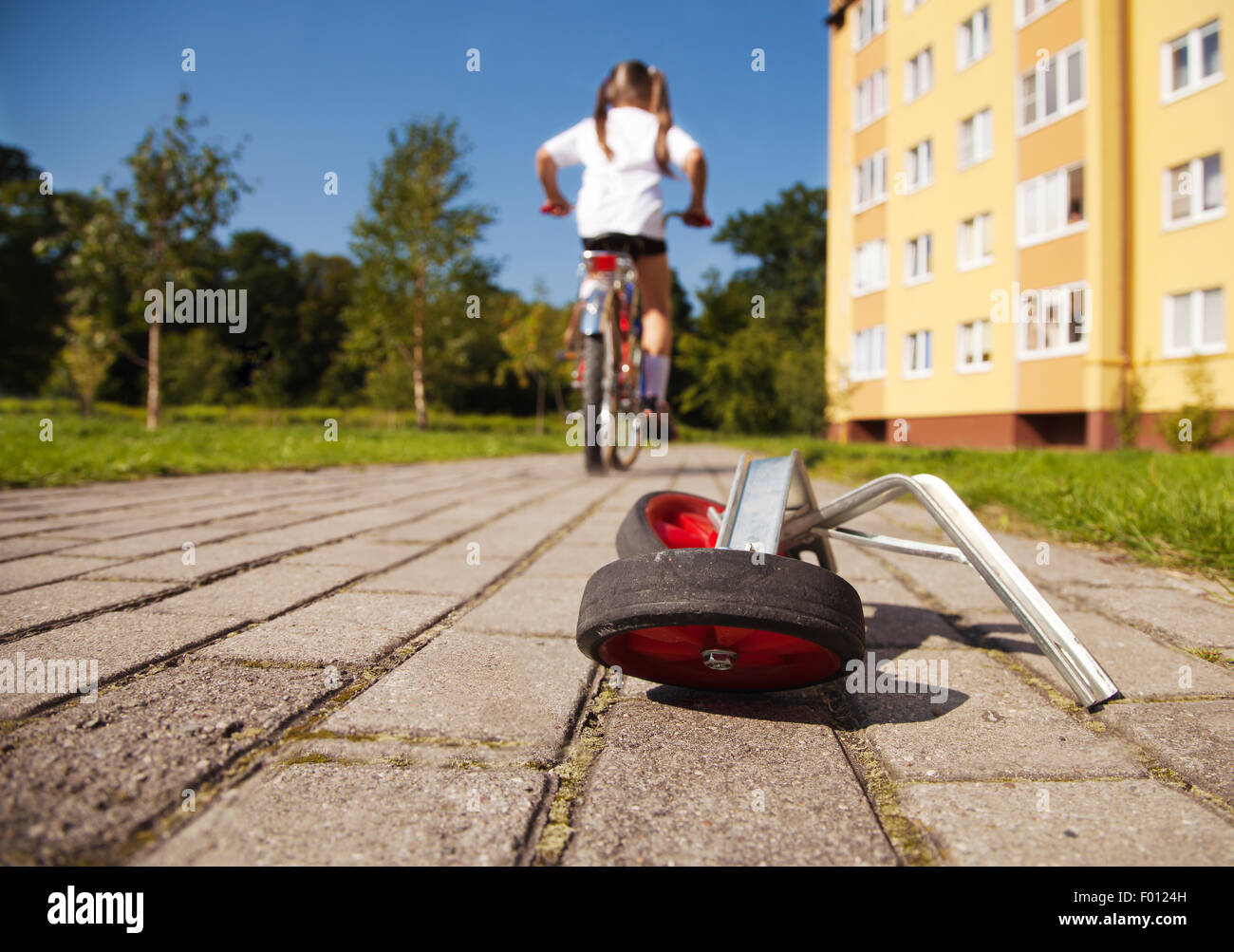 Girl on bike with training wheels hi-res stock photography and images ...