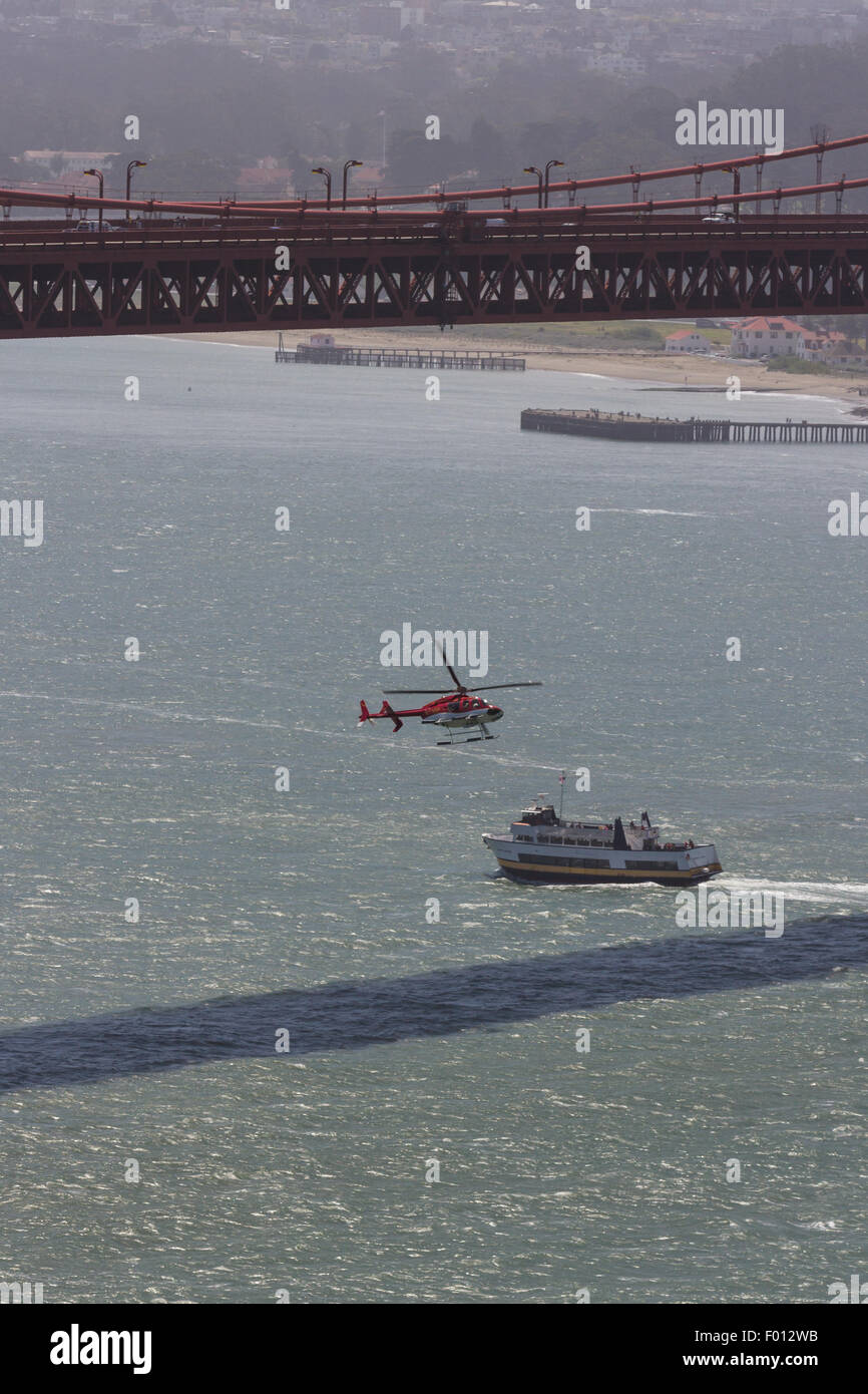 San Francisco, California - May 11 : Helicopter flying under the Golden ...
