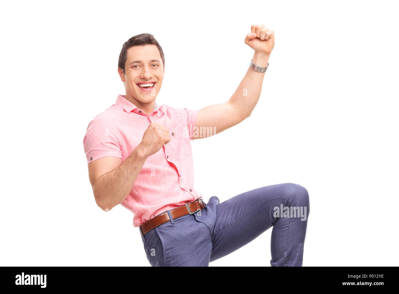 Excited young guy gesturing happiness and looking at the camera ...