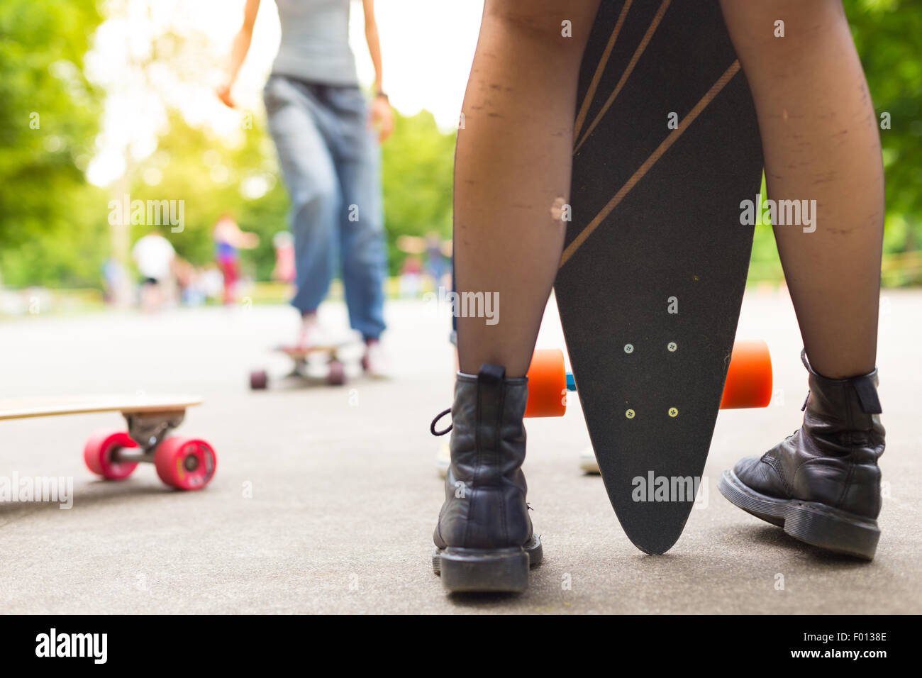 Teenage girl urban long board riding Stock Photo - Alamy
