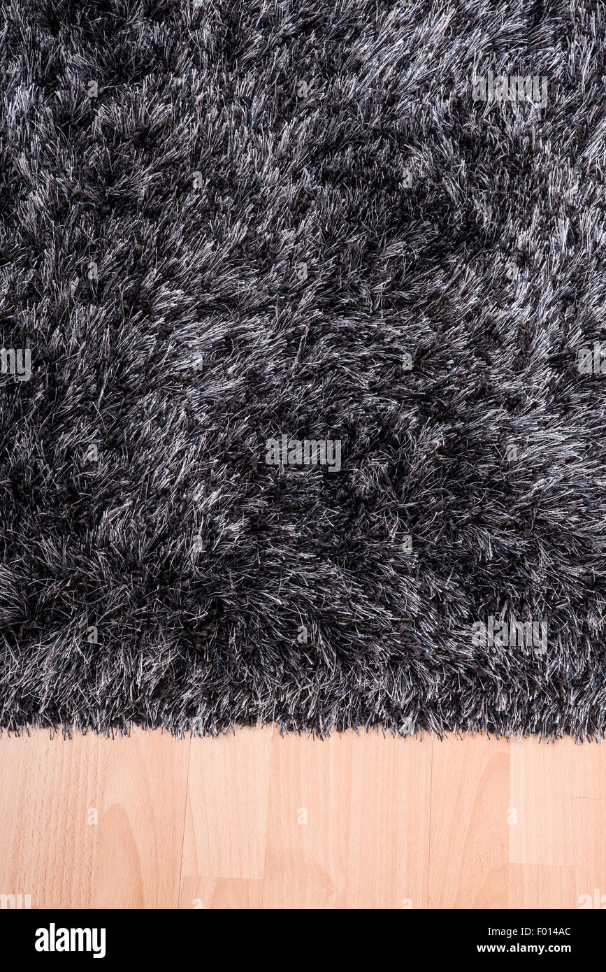 A fuzzy grey carpet lying on the floor Stock Photo - Alamy