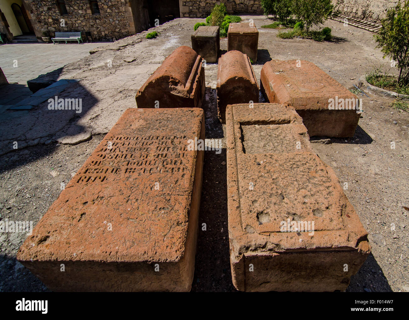 Ancient stone tombs arranged in a historic site under bright sunlight ...