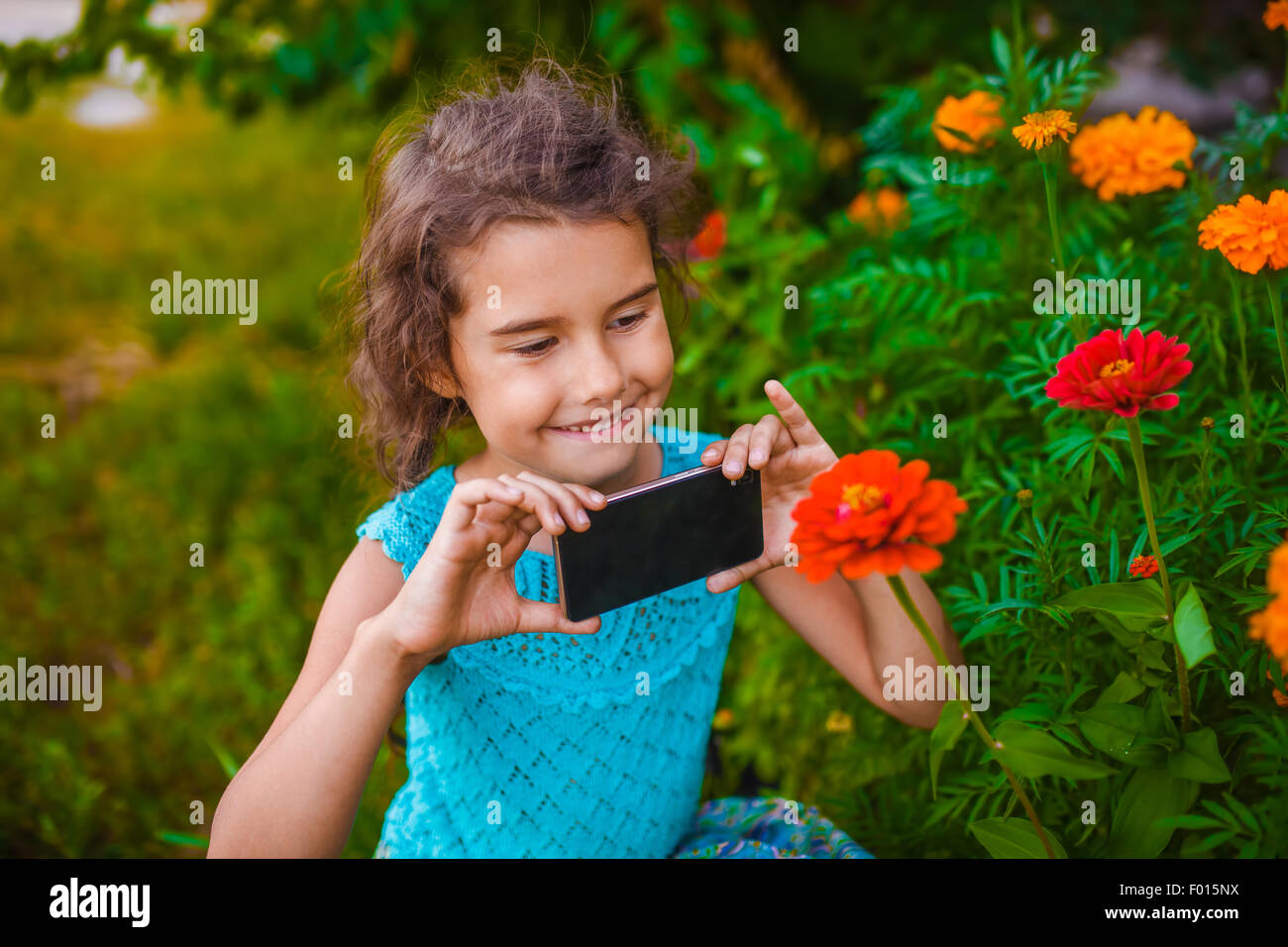 Teen girl child photographed flower on the outside phone nature Stock ...