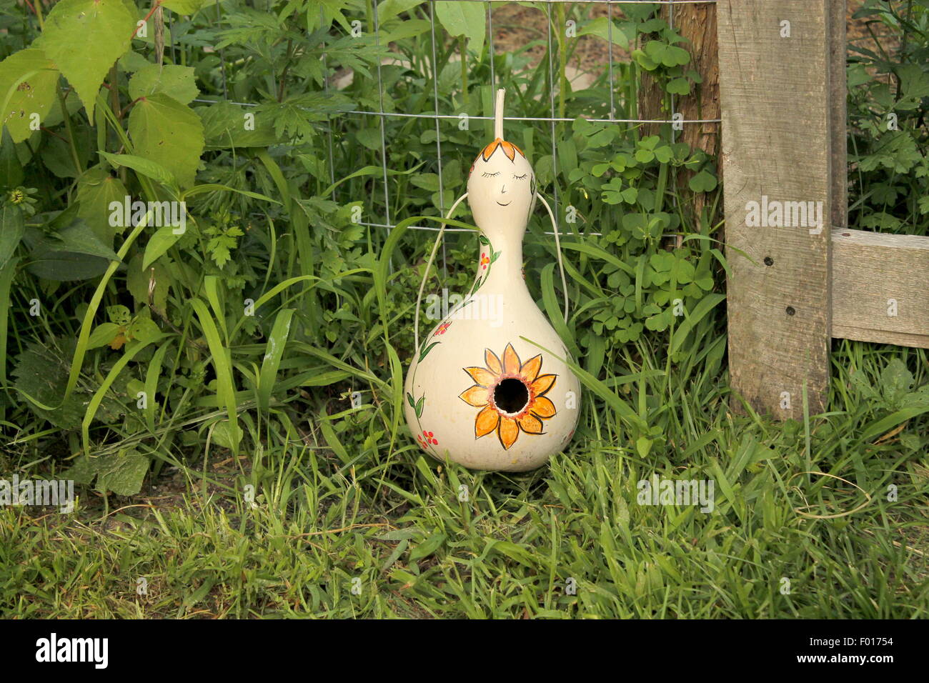 A hand painted gourd stands by the garden gate Stock Photo - Alamy