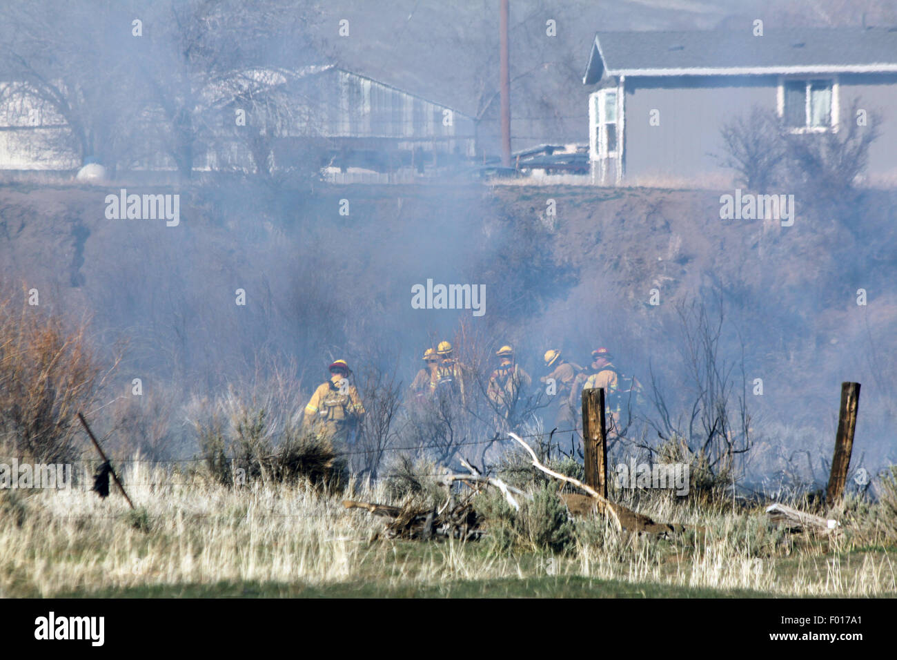 Firemen fighting a fire Stock Photo - Alamy