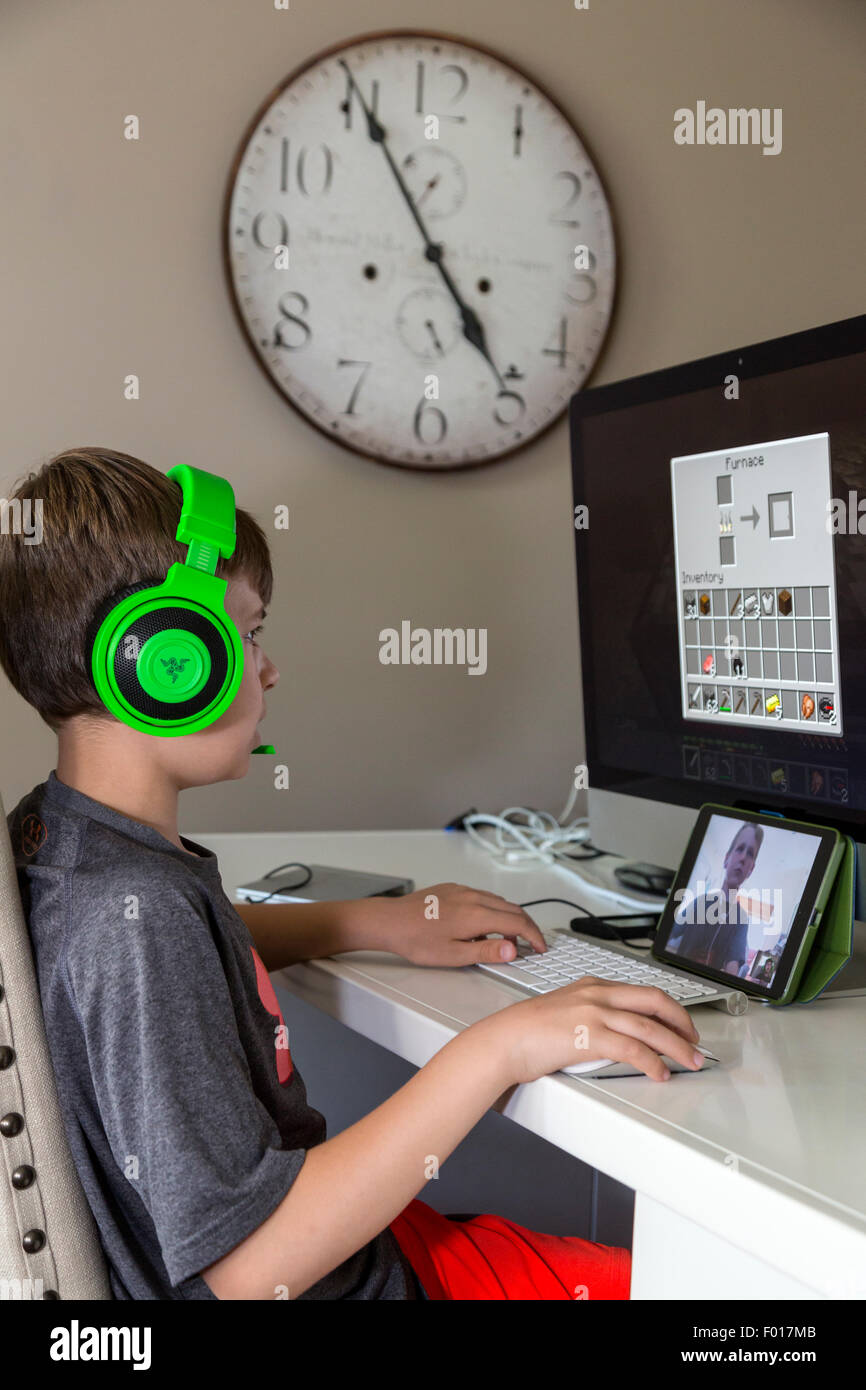 Two Young Boys Play Video Games at Long Distance, Communicating via ...