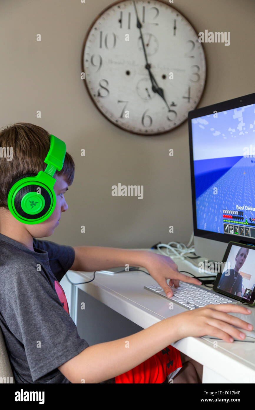 Two Young Boys Play Video Games at Long Distance, Communicating via ...