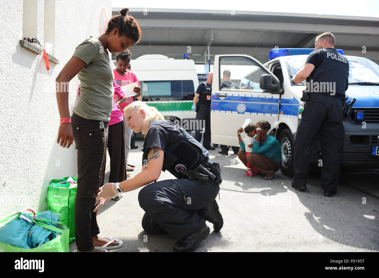 Rosenheim, Germany. 04th Aug, 2015. Ruth from Eritrea is frisked by ...