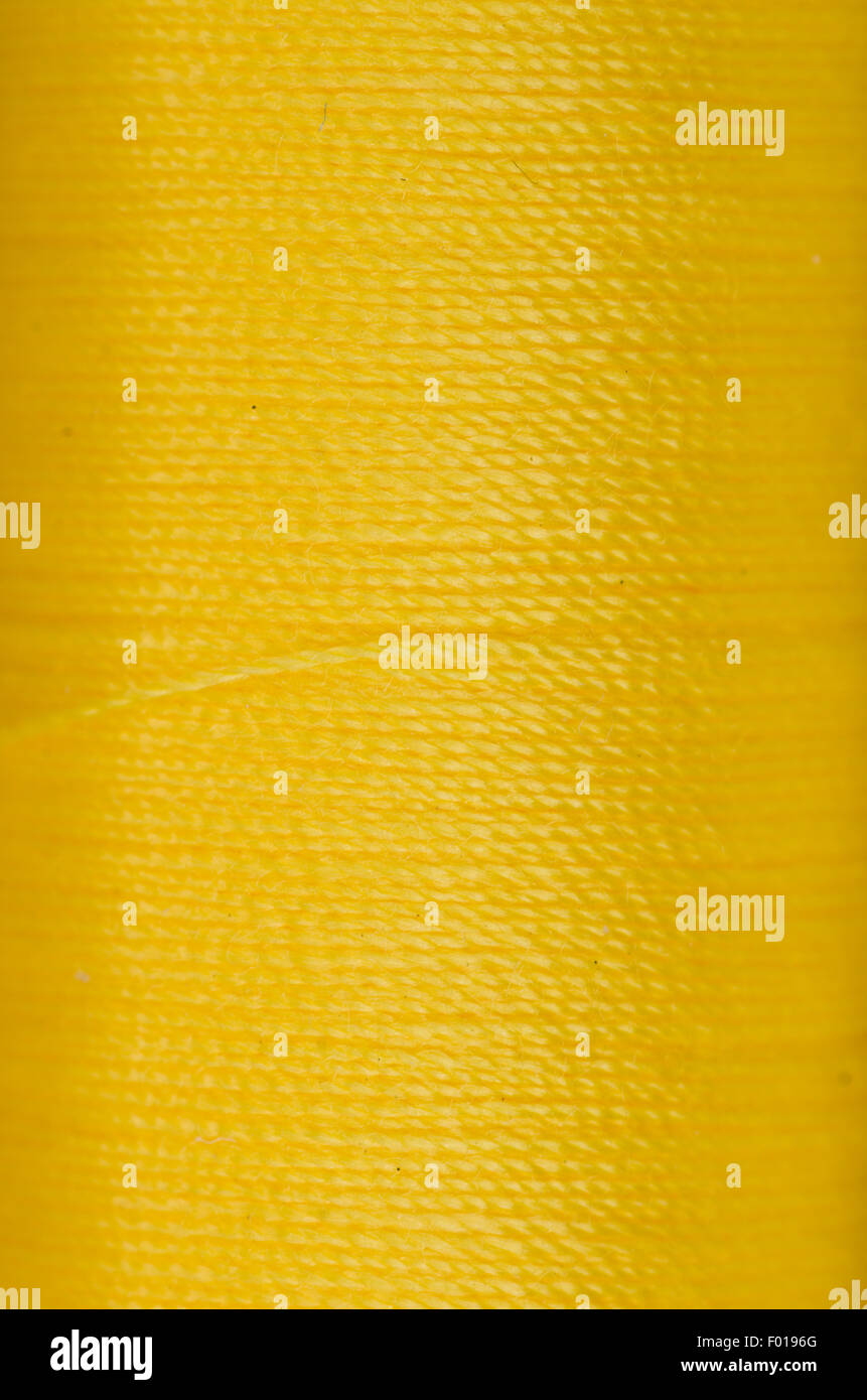bobbin of yellow thread background texture macro Stock Photo - Alamy