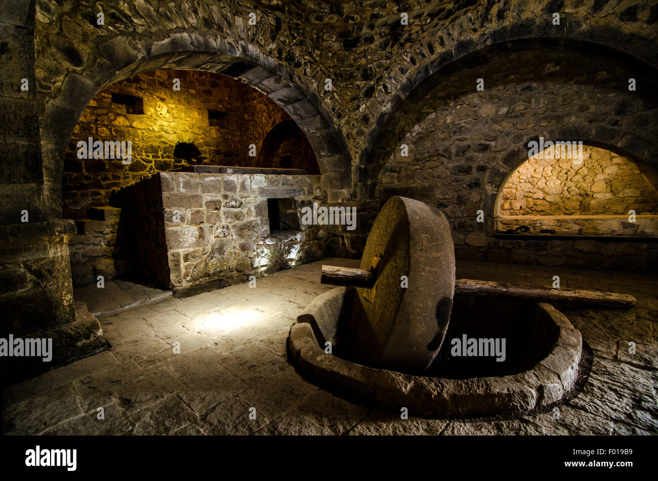 Exploring an ancient stone structure featuring a large grinding wheel ...