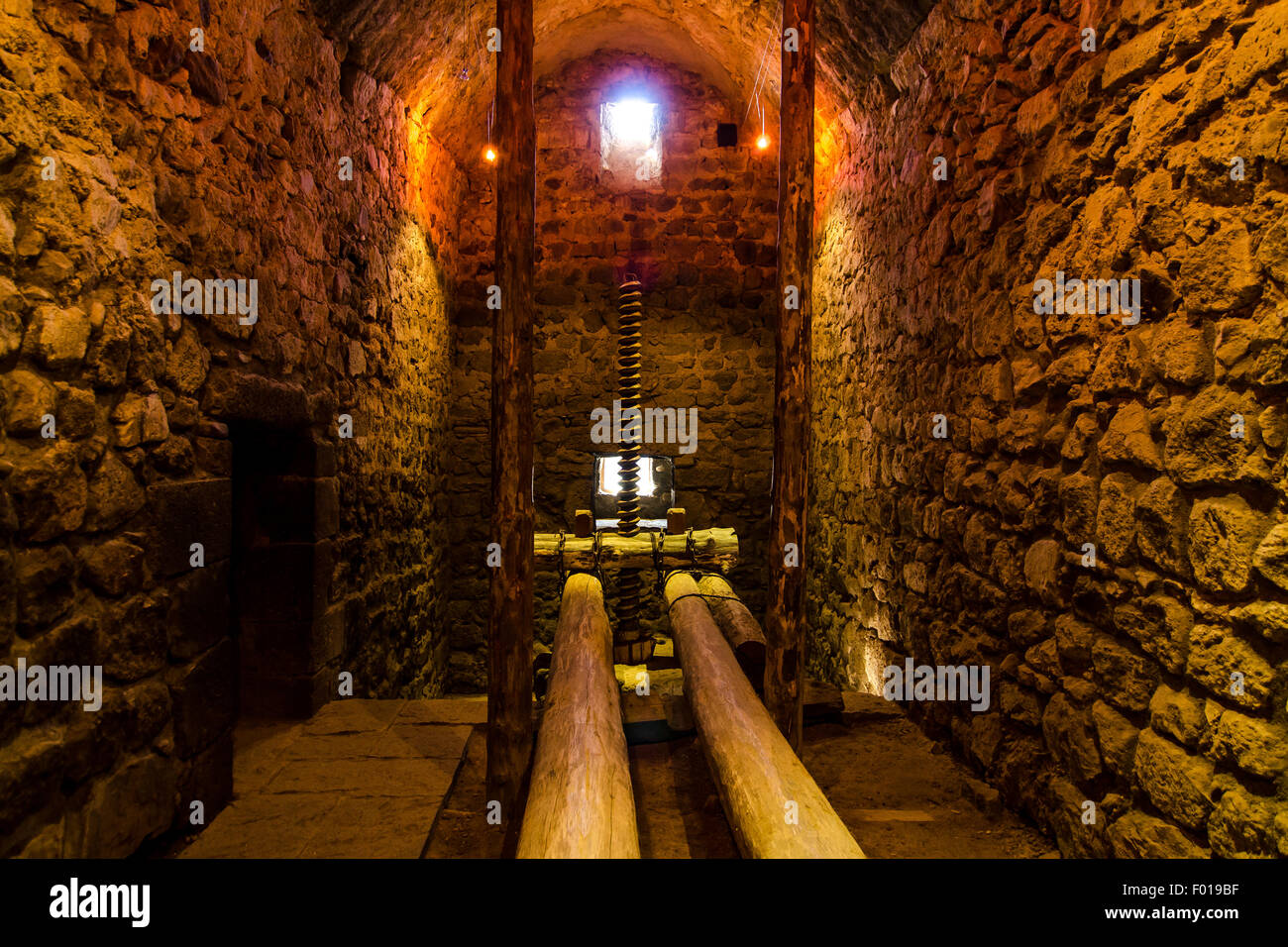 Exploring an ancient stone structure featuring a large grinding wheel ...