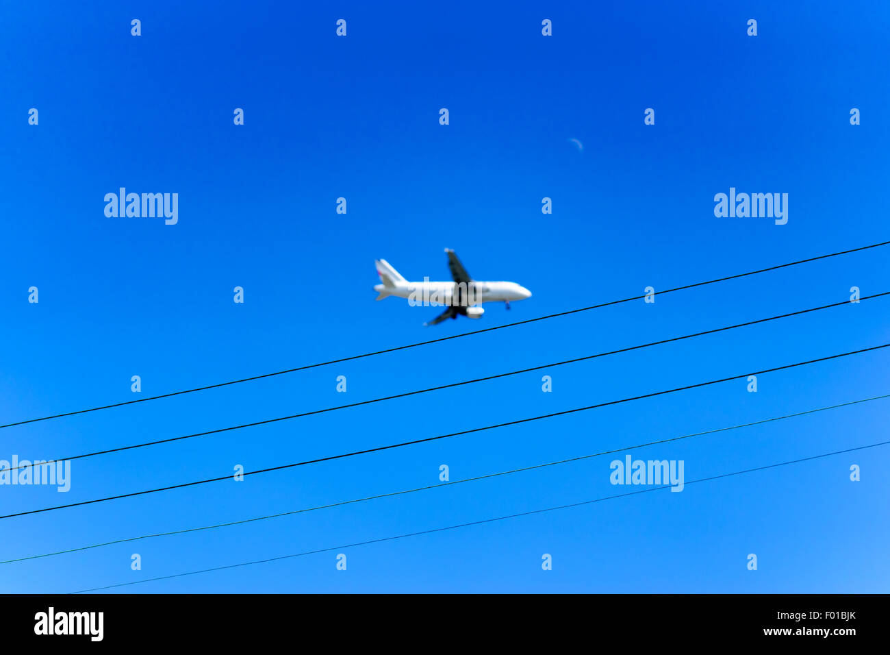 modern jet passenger aircraft flying in blue sky Stock Photo - Alamy