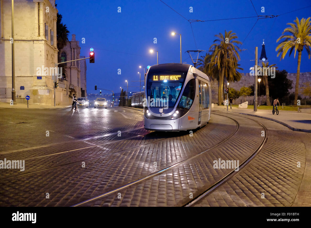The Jerusalem Light Rail or Jerusalem Tramway pass at twilight through ...