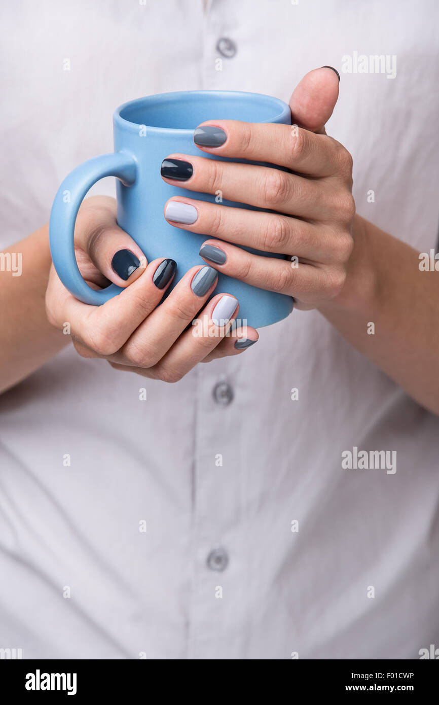 Female hands with blue cup Stock Photo - Alamy