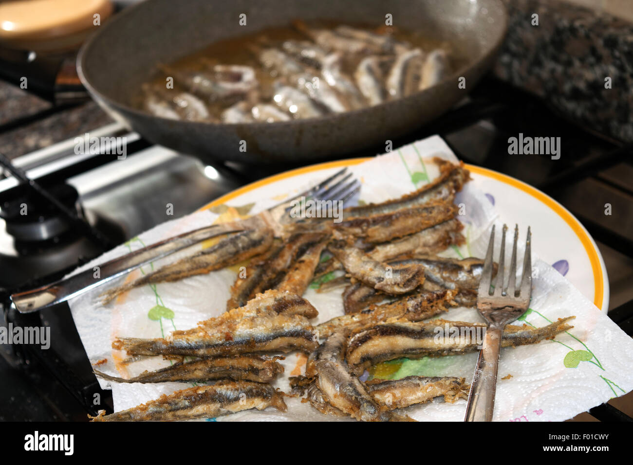 fillet of anchovies during the fry in a pan Stock Photo - Alamy