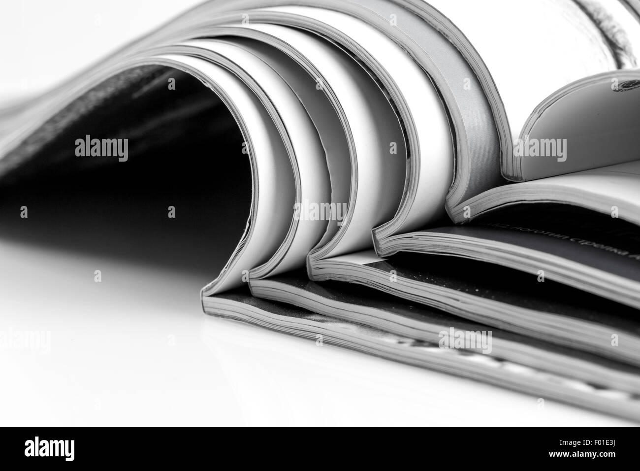 Stack of magazines on white background with reflection Stock Photo - Alamy