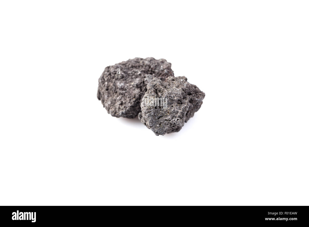 Black lava rock from volcano on a white background Stock Photo - Alamy