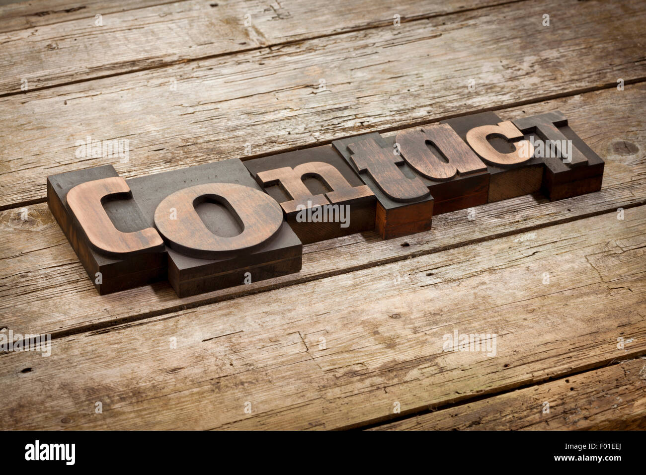 contact, word written with vintage letterpress printing blocks, angled ...