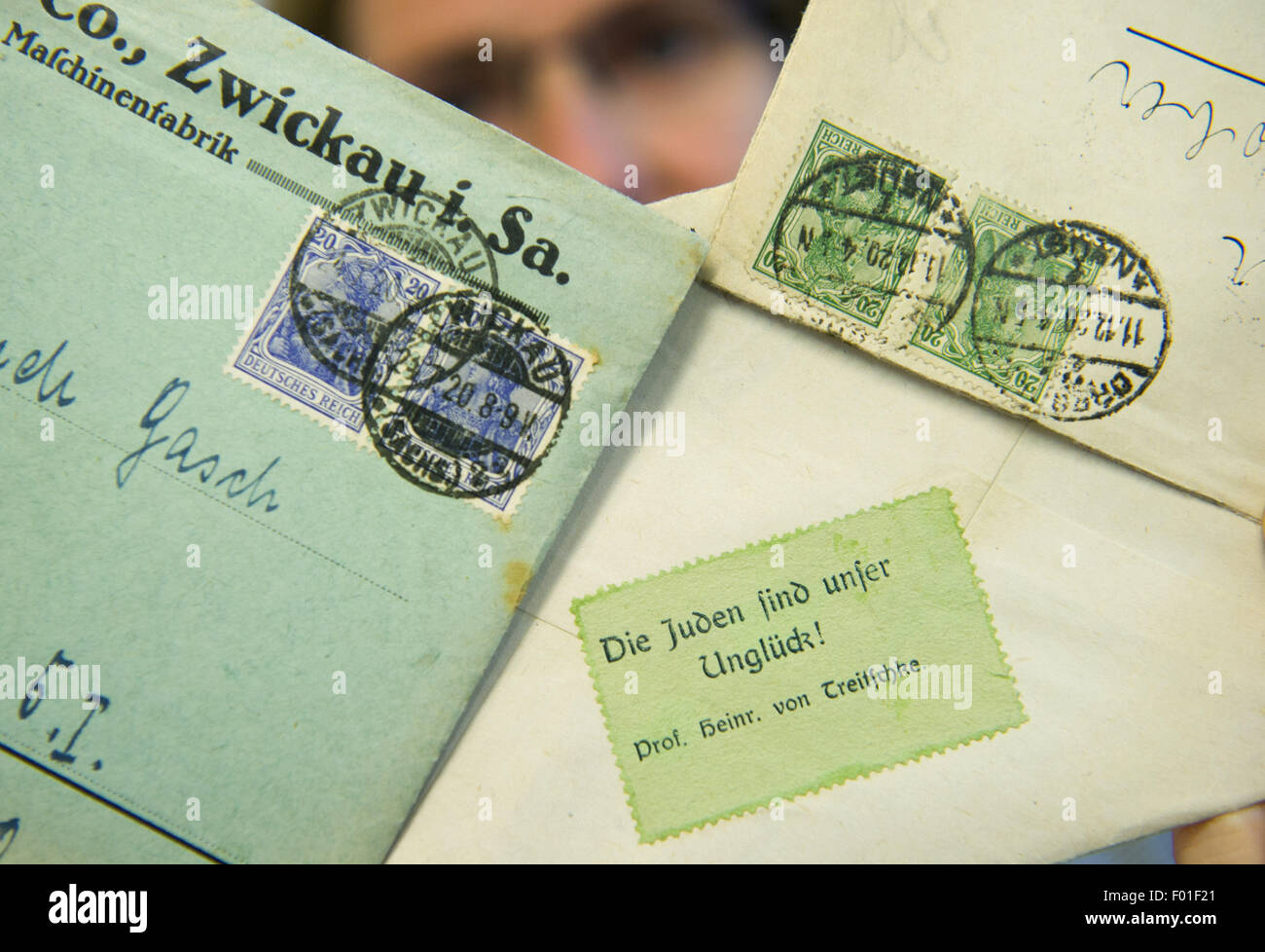Curator Isabel Enzenbach presents a sticker on a set of letters which ...
