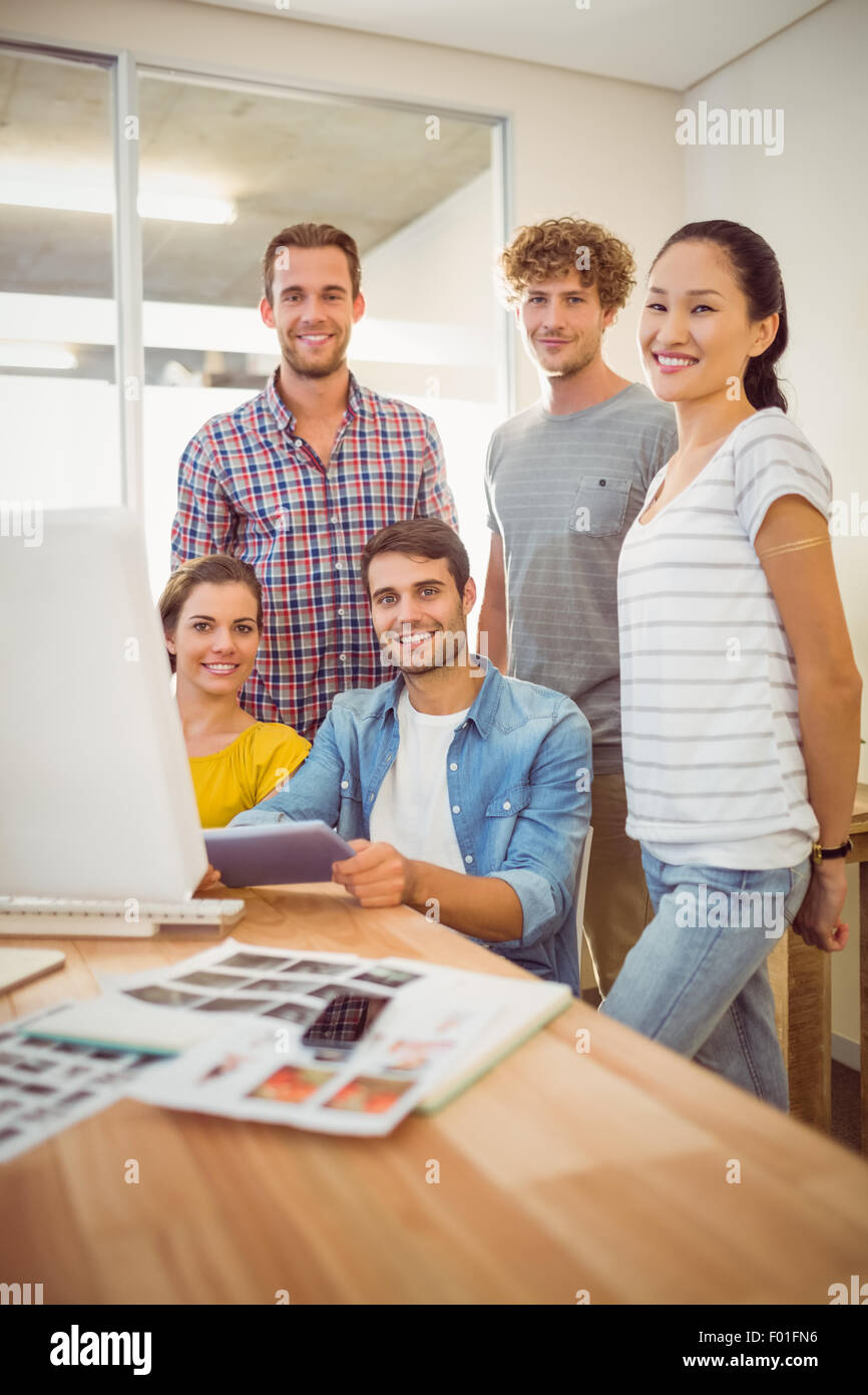 Gathered creative business team smiling at the camera Stock Photo - Alamy