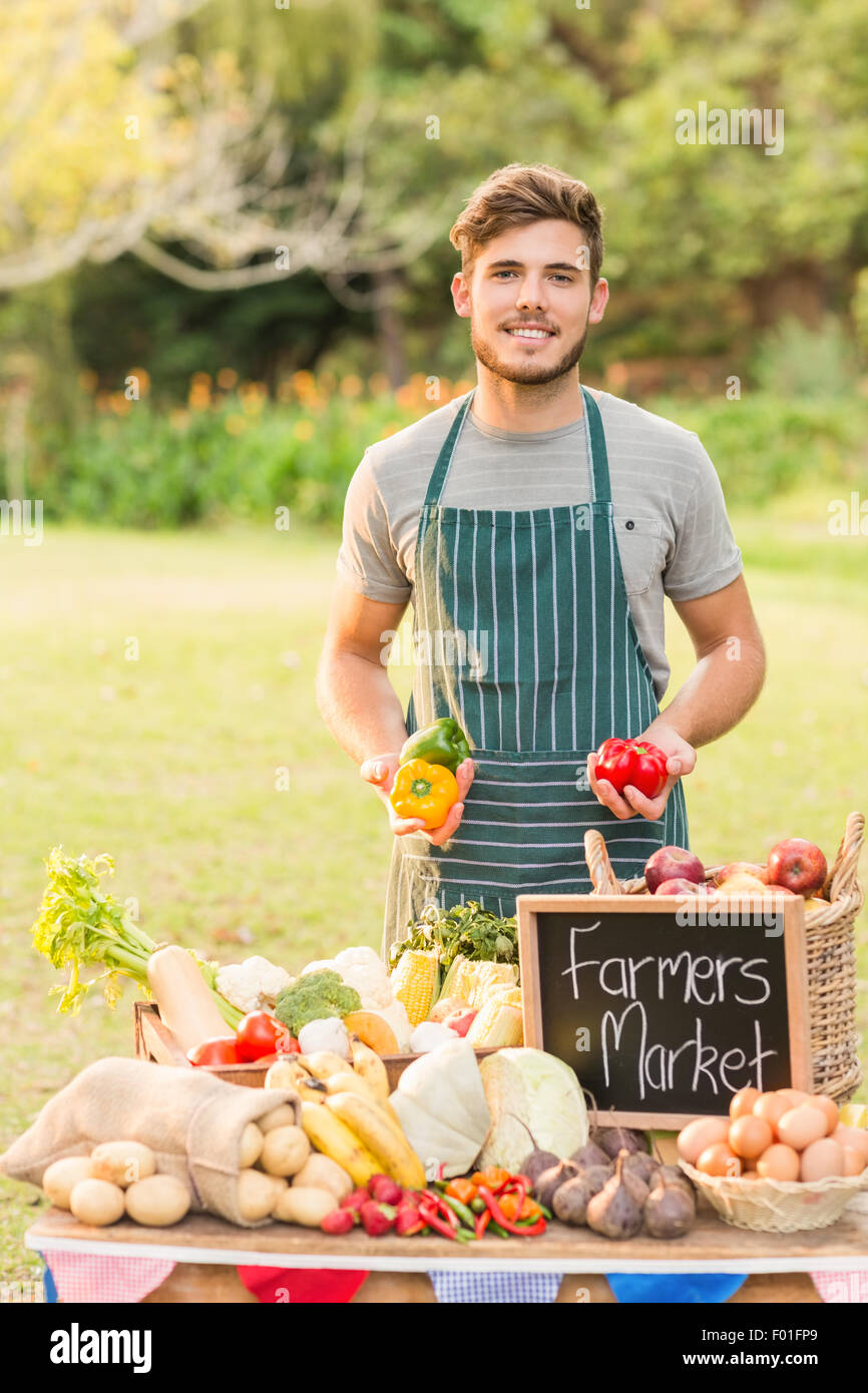Handsome farmer holding peppers Stock Photo - Alamy