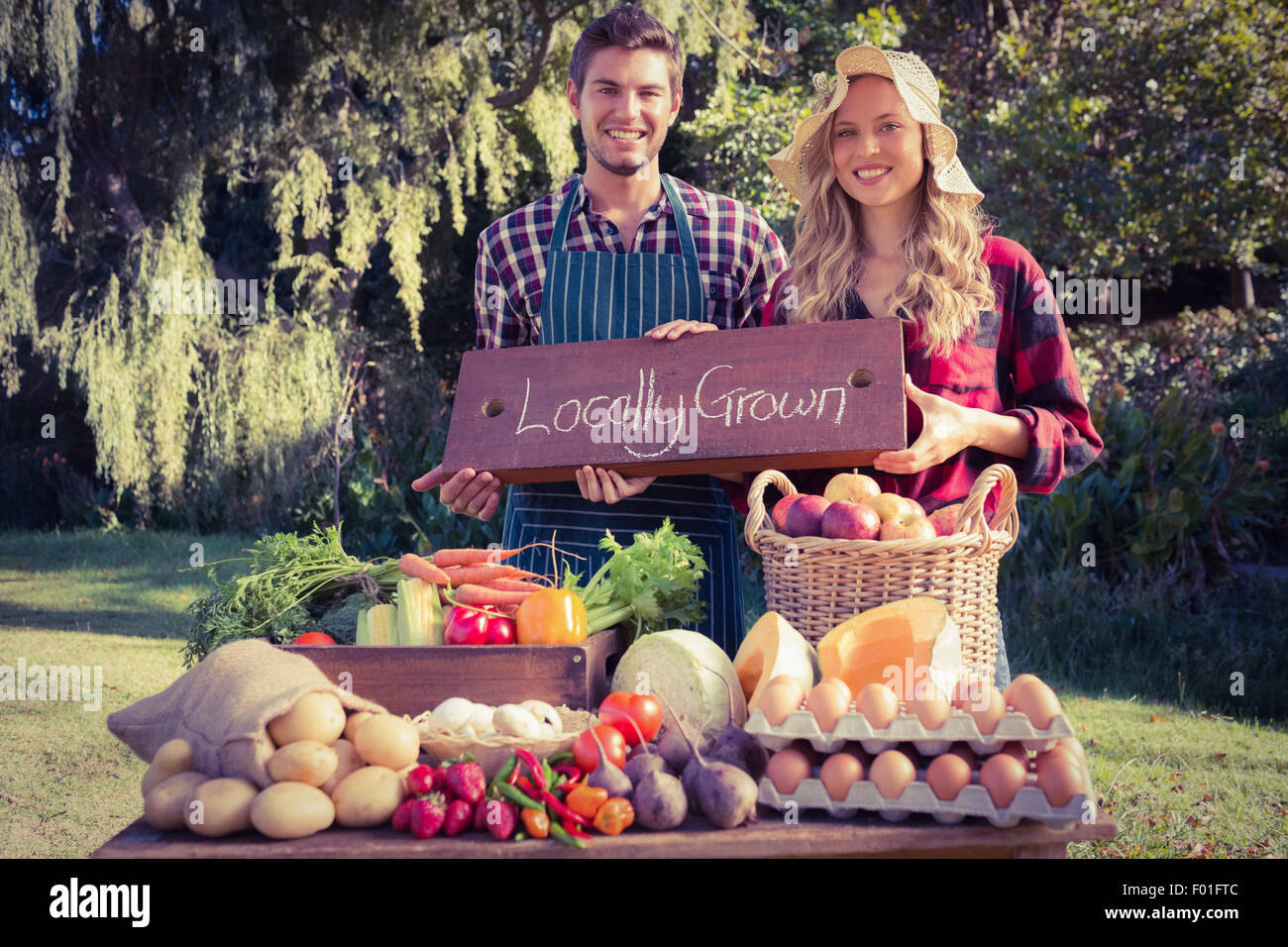 Happy farmers standing at their stall Stock Photo - Alamy