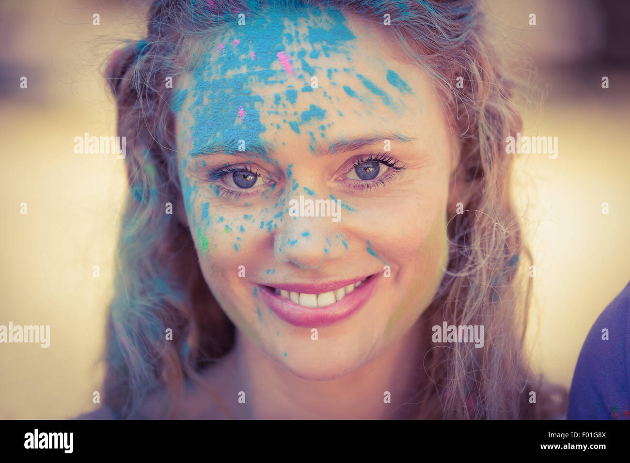 Pretty blonde covered with powder paint Stock Photo - Alamy