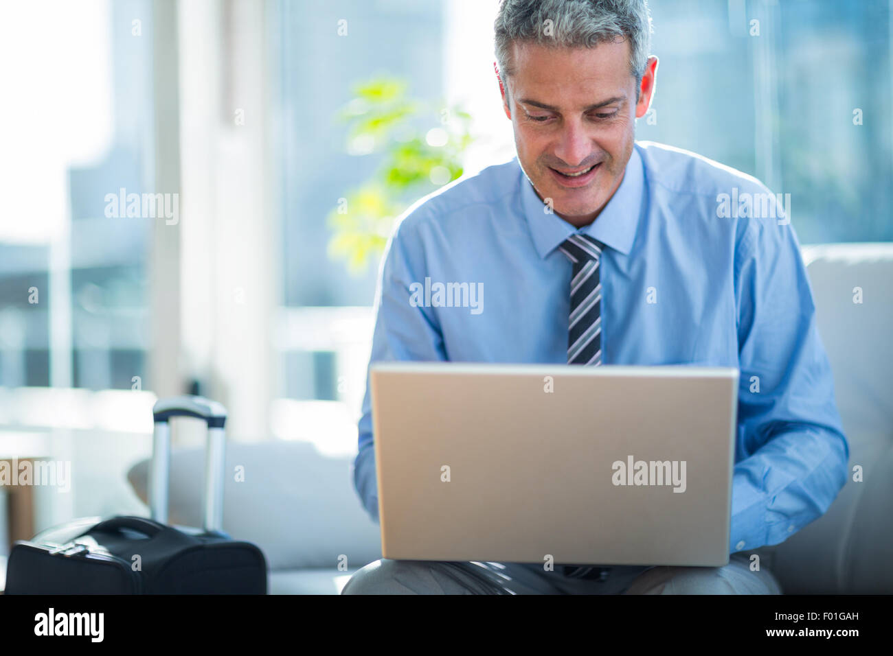 Happy businessman using laptop computer Stock Photo - Alamy