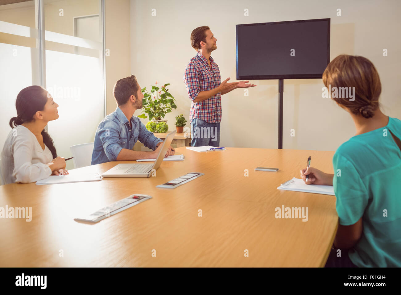 Woman making presentation colleagues hi-res stock photography and ...