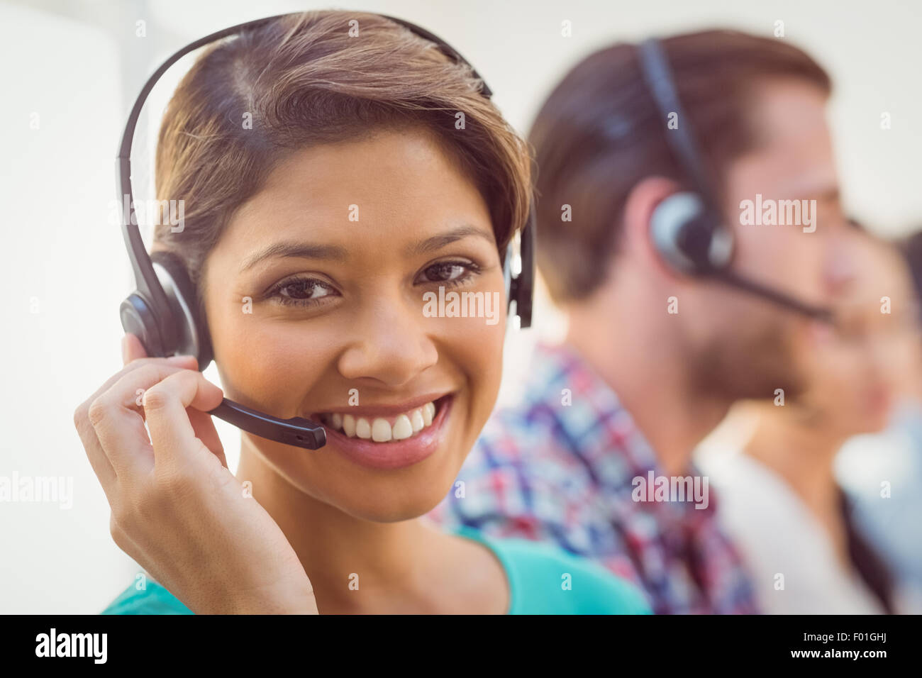 Pretty smiling businesswoman working in a call centre Stock Photo - Alamy