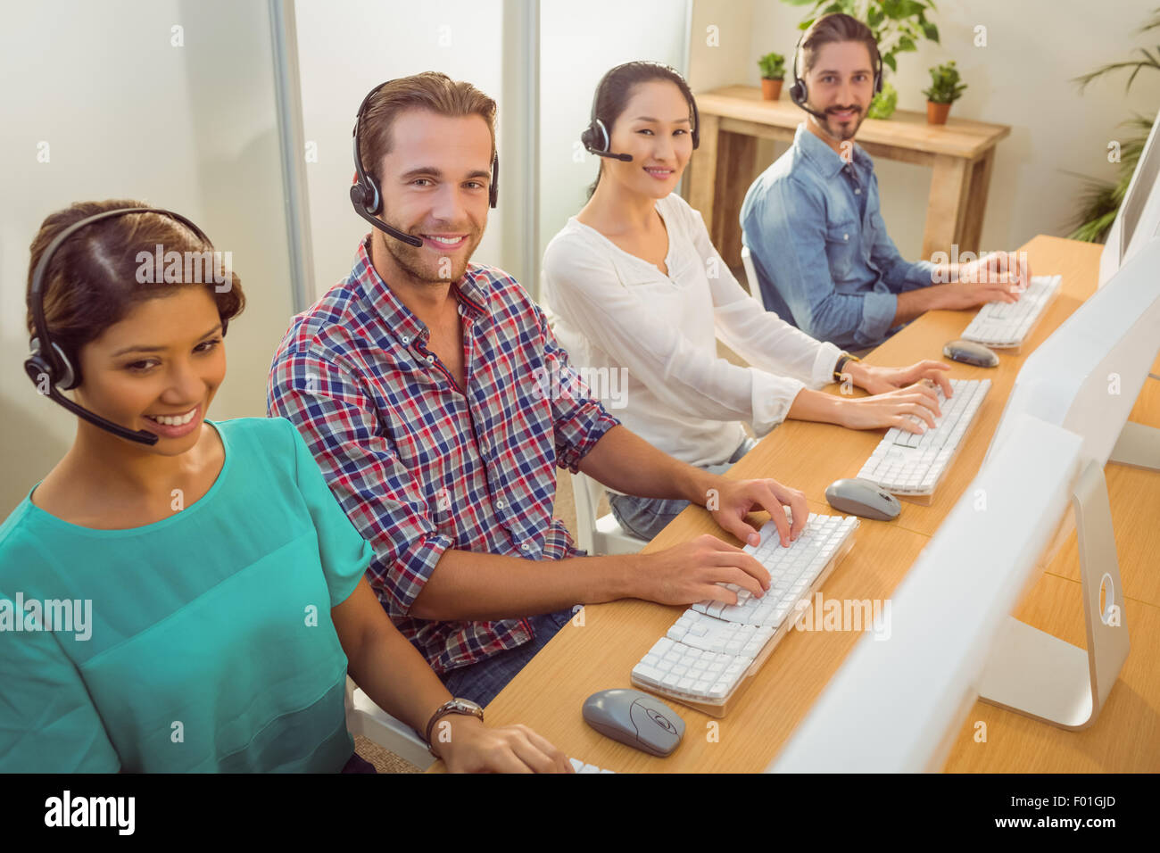 Smiling customer support team hi-res stock photography and images - Alamy