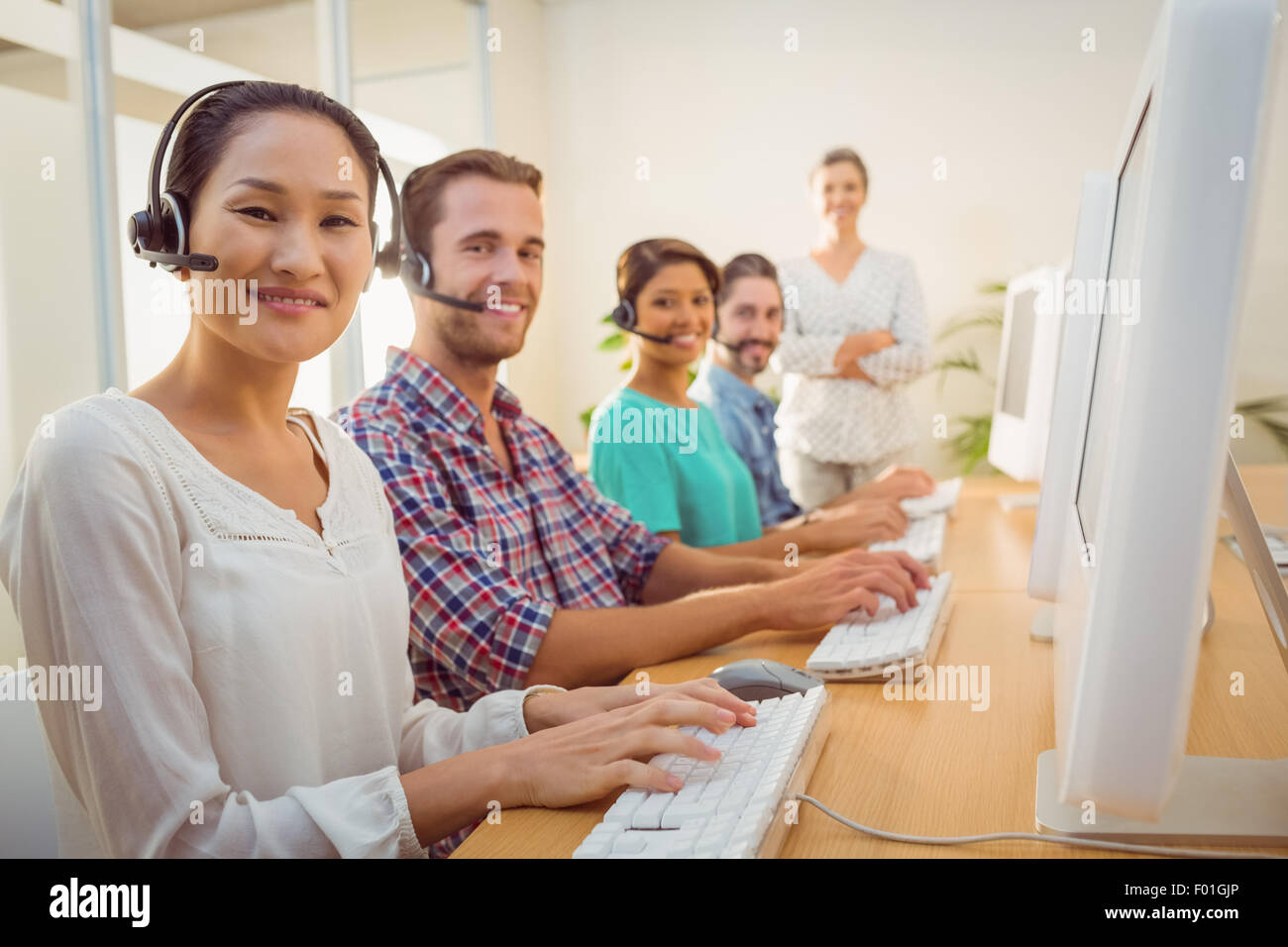 Call center agent working under a manager supervision Stock Photo - Alamy