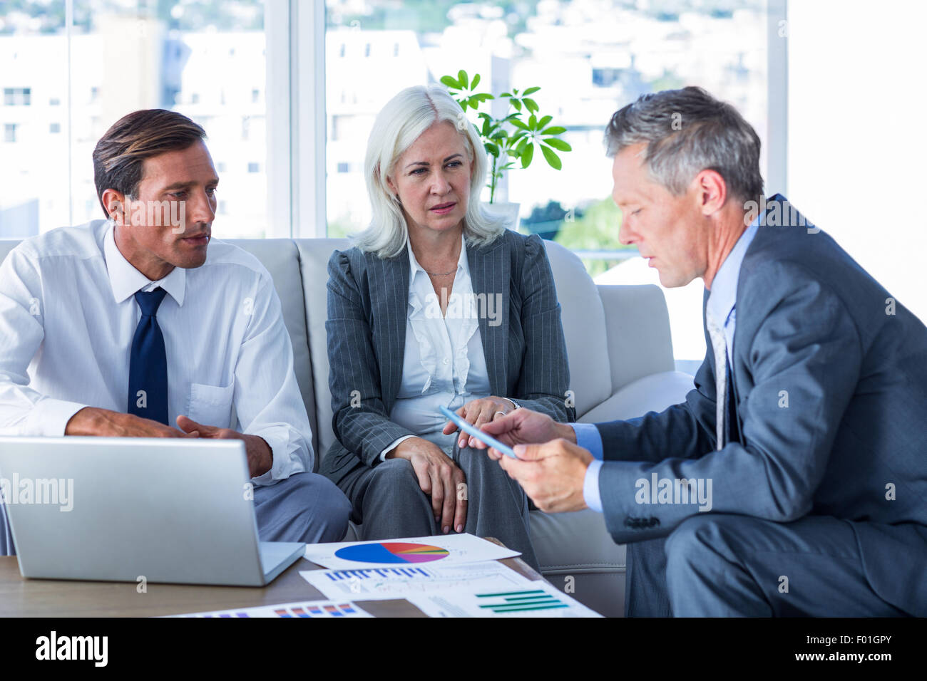 Business people speaking together on couch Stock Photo - Alamy